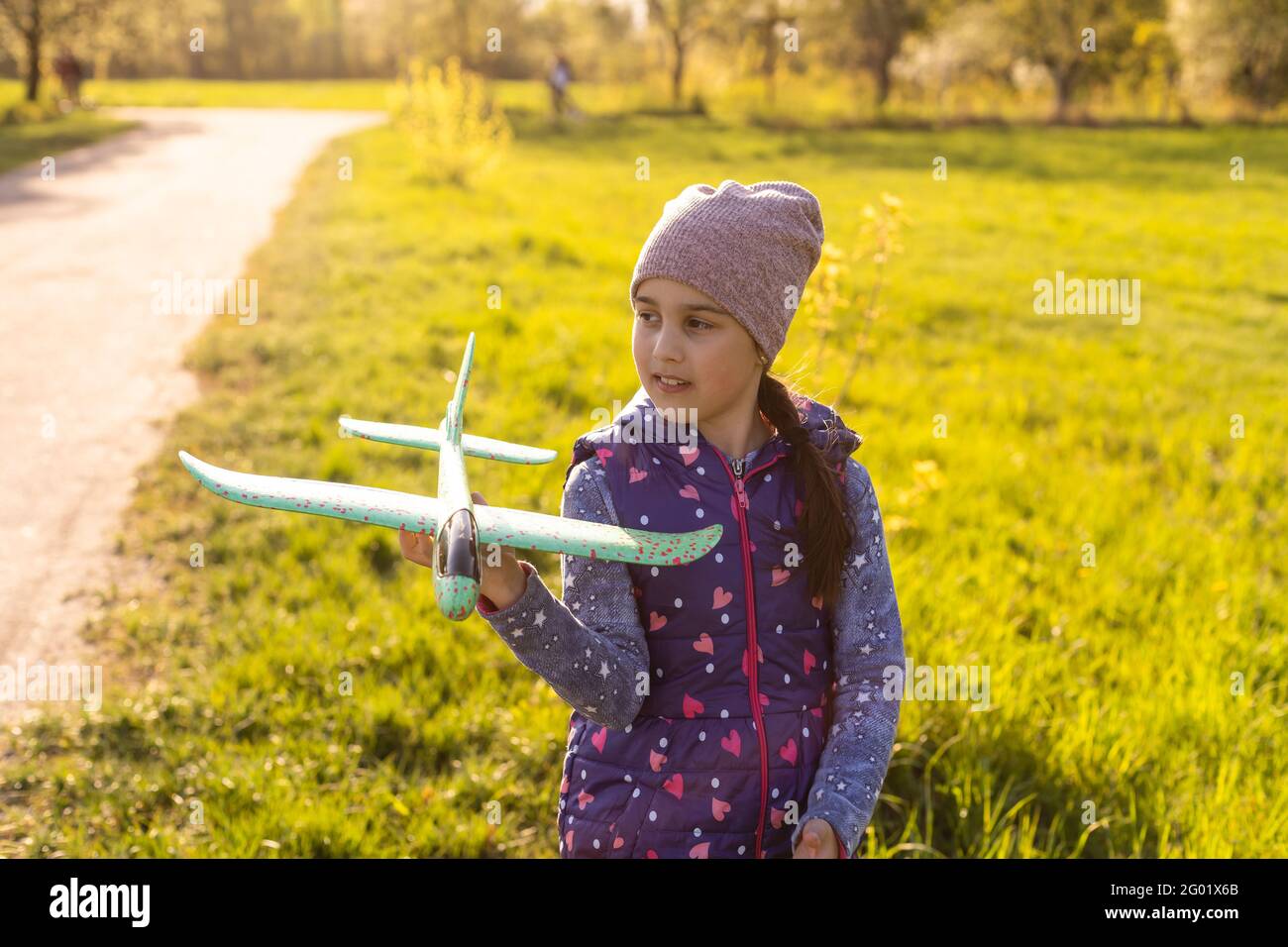 little girl with toy airplane in hands outdoor, screw wind-stick of ...