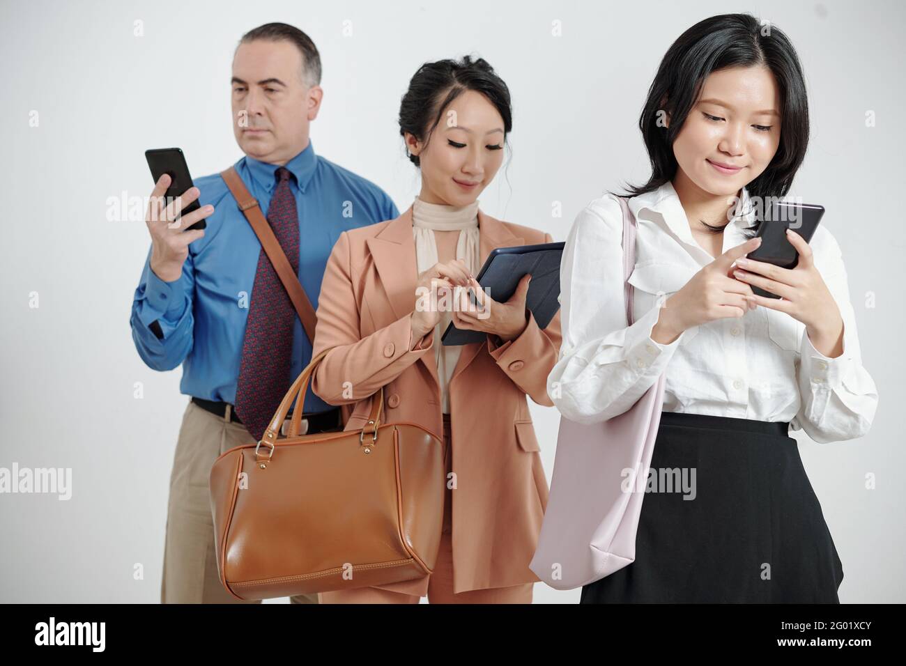 Business people checking social media or reading news on smartphones ...