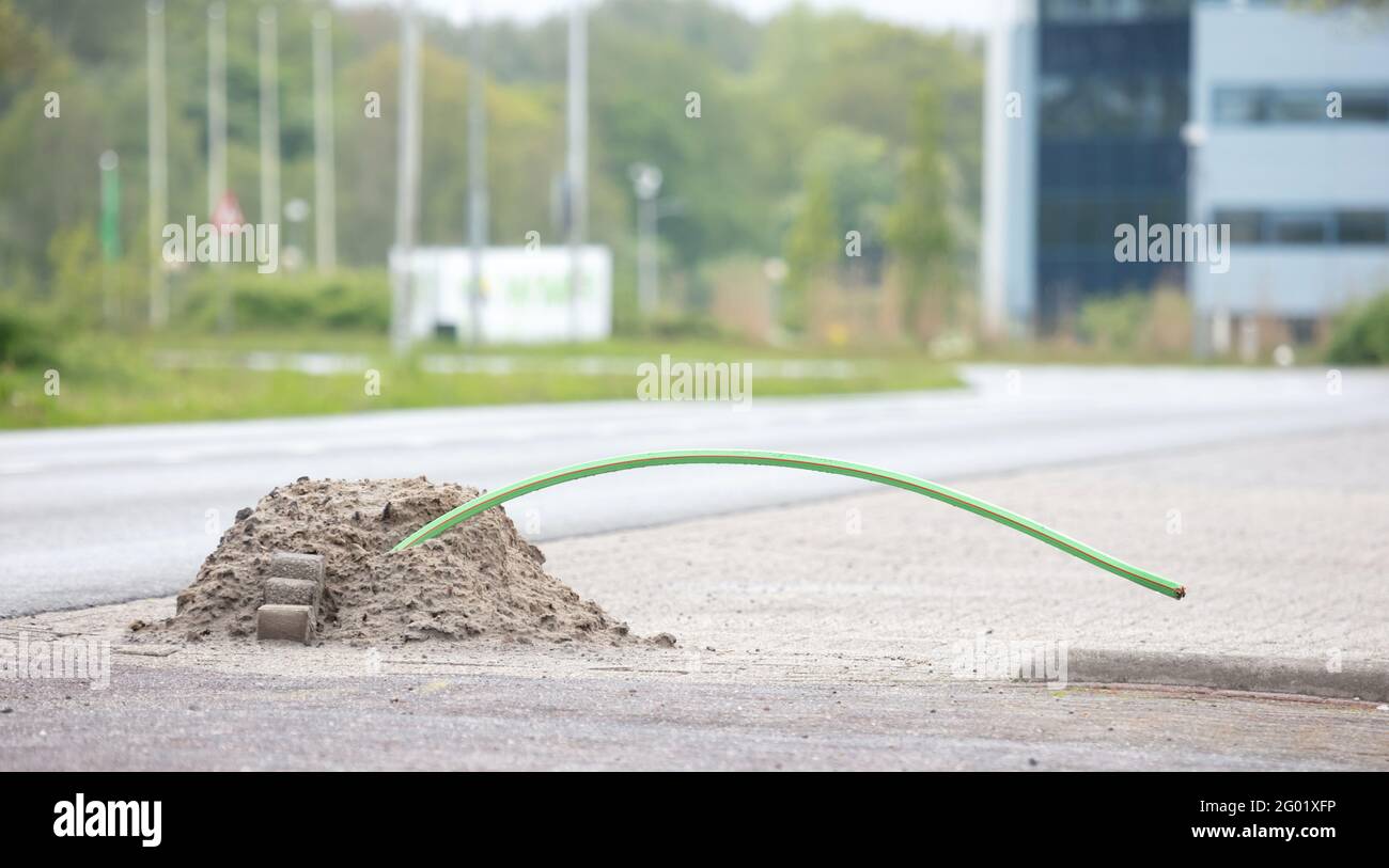 Cable out of the ground, ready to be installed Stock Photo - Alamy