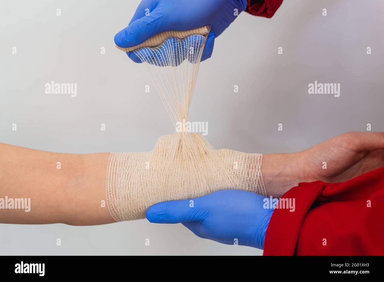 Doctor first aid patient's arm sprain with elastic bandage Stock Photo ...