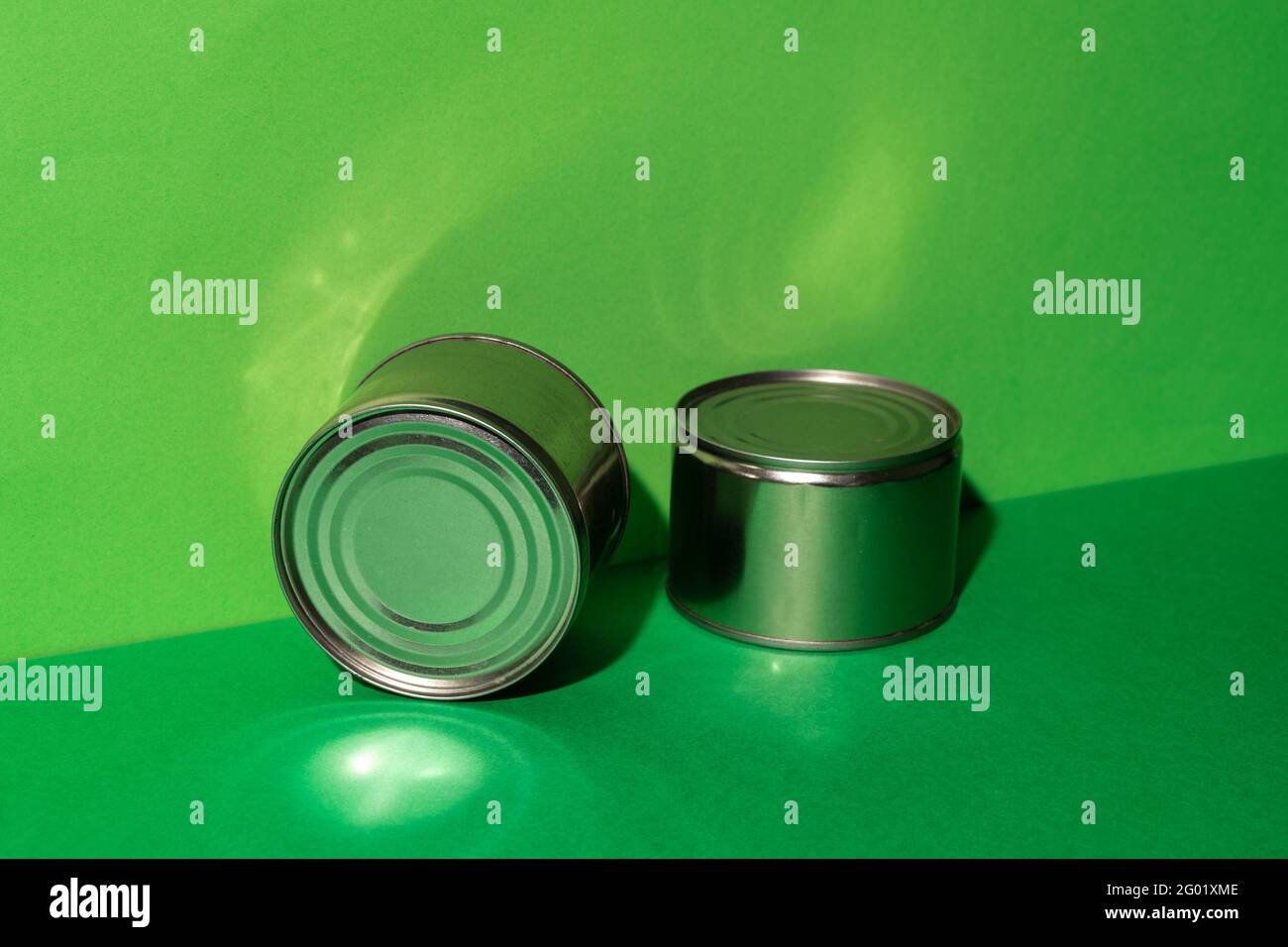 Canned food tin on green studio background Stock Photo - Alamy