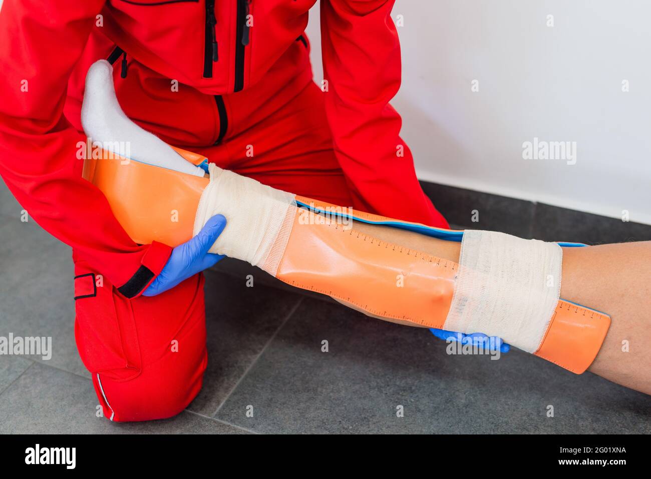 Injury leg. Young man with injured leg. Young woman doctor helps the ...