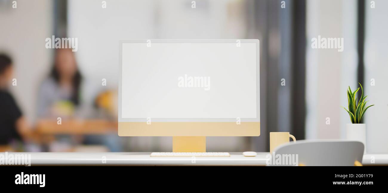 Yellow pastel monitor with mock-up screen on office desk in blurred ...
