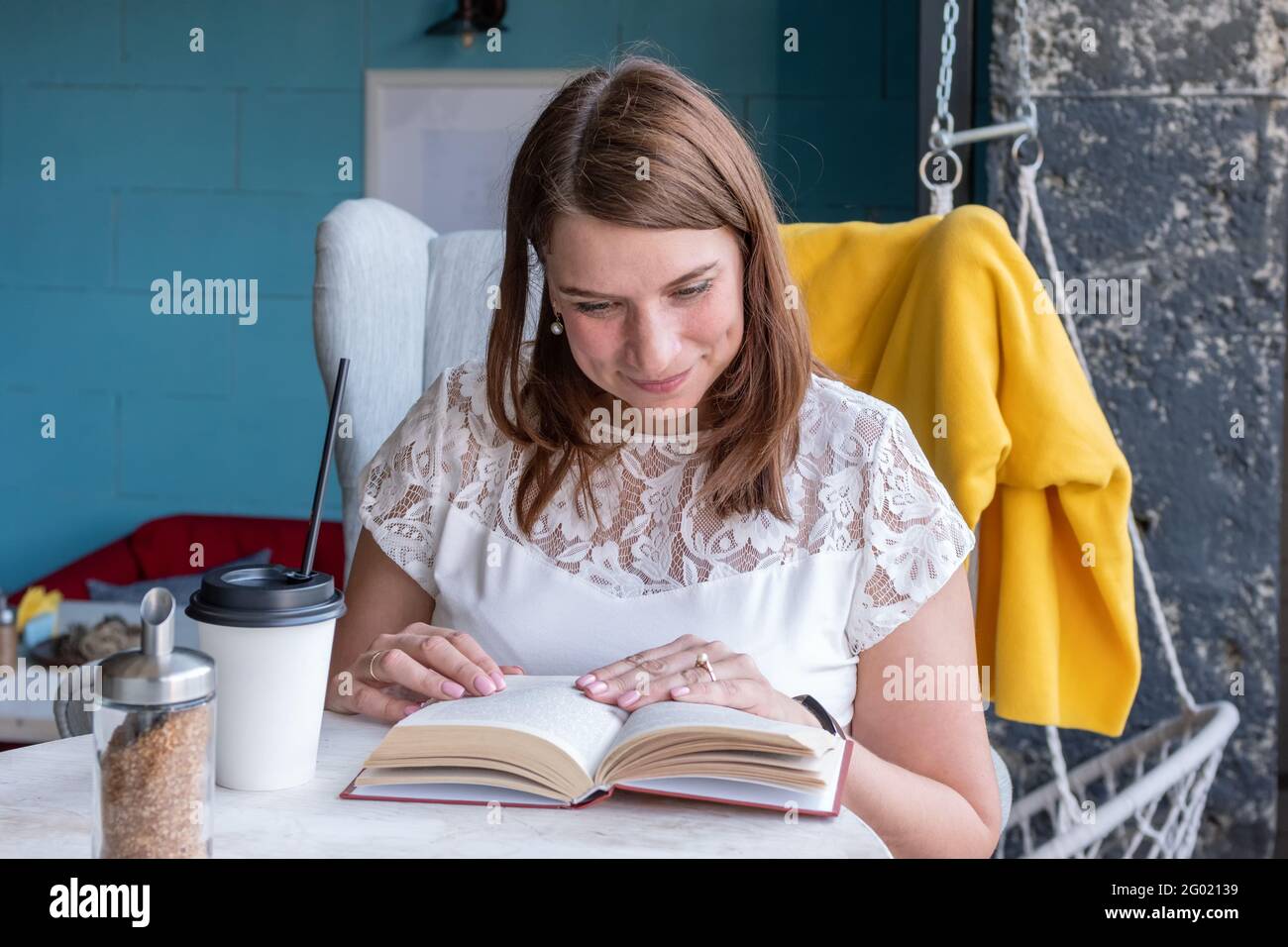 Smiling girl reading book mother hi-res stock photography and images ...