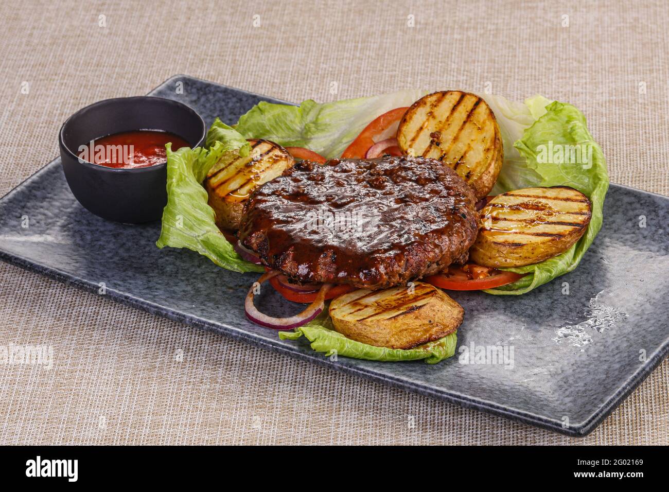Grilled Beef cutlet with vegetables served onion Stock Photo - Alamy