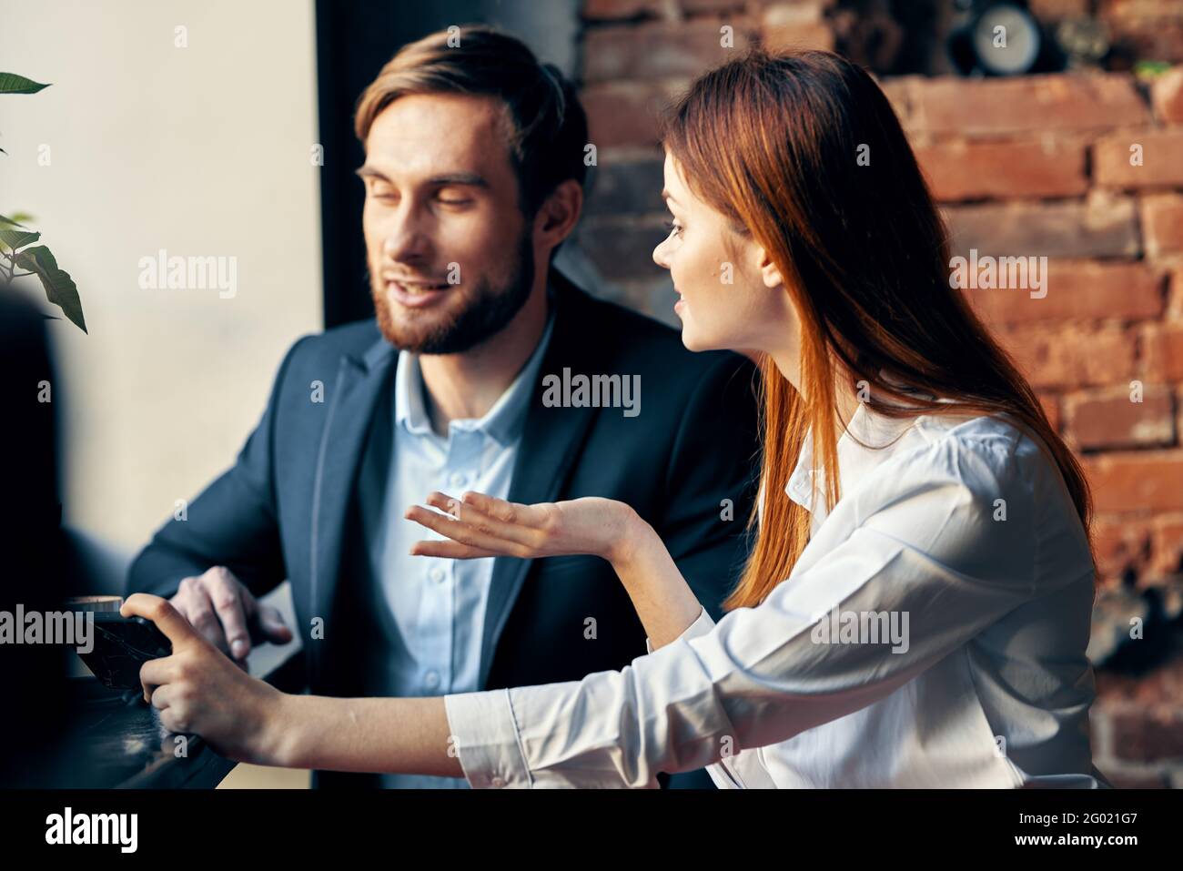 Cheerful man and woman work colleagues socializing in cafe lifestyle ...
