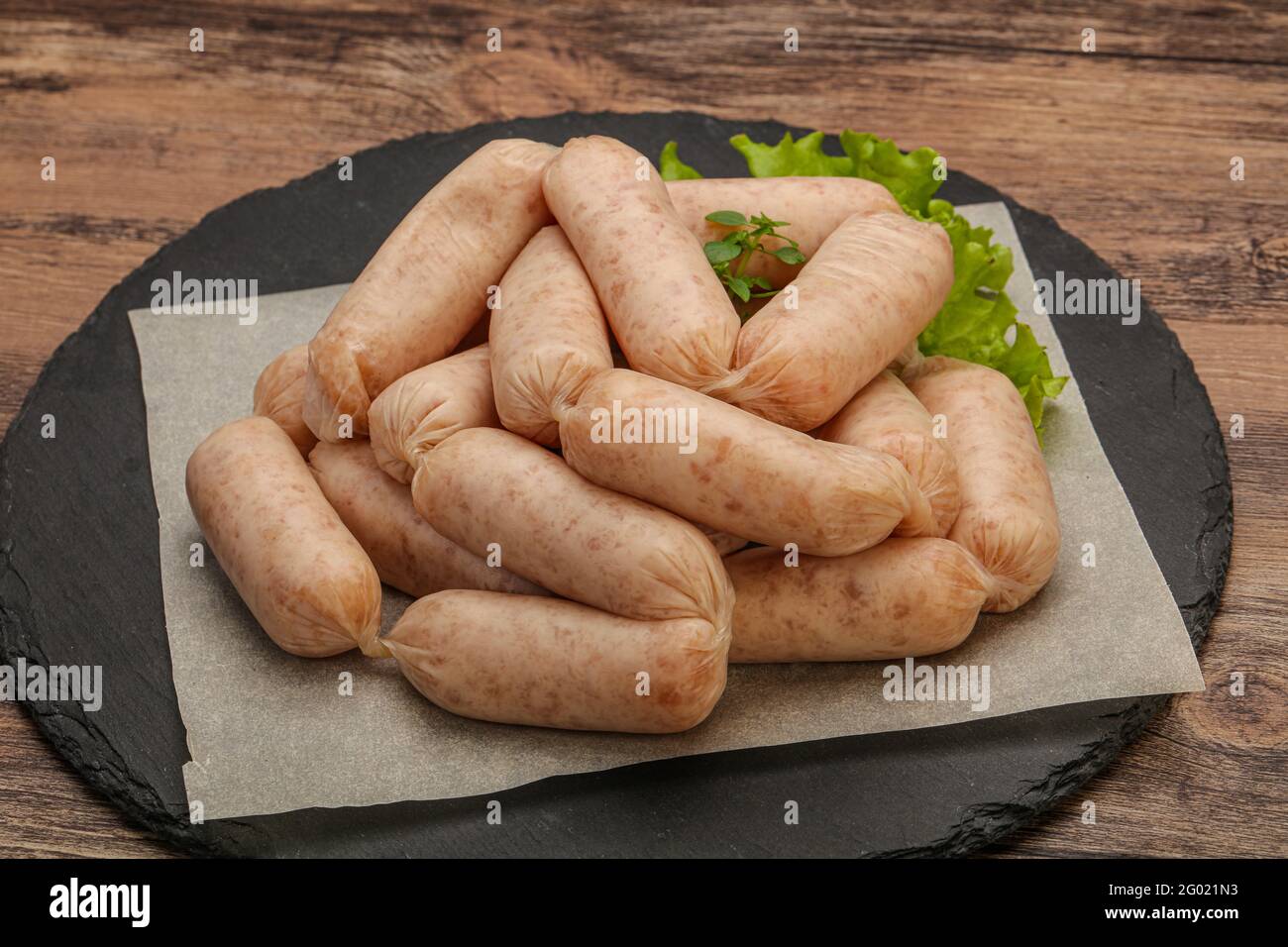 Raw natural chicken baby sausages for roast Stock Photo - Alamy