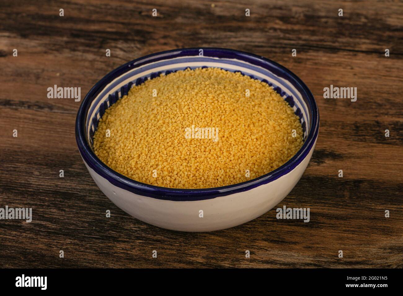 Raw cous cous heap in the bowl for cooking Stock Photo - Alamy