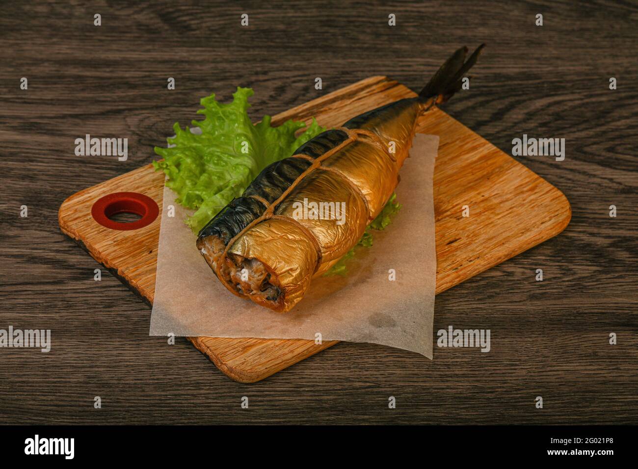 Smoked tasty mackerel fish snack over board Stock Photo - Alamy
