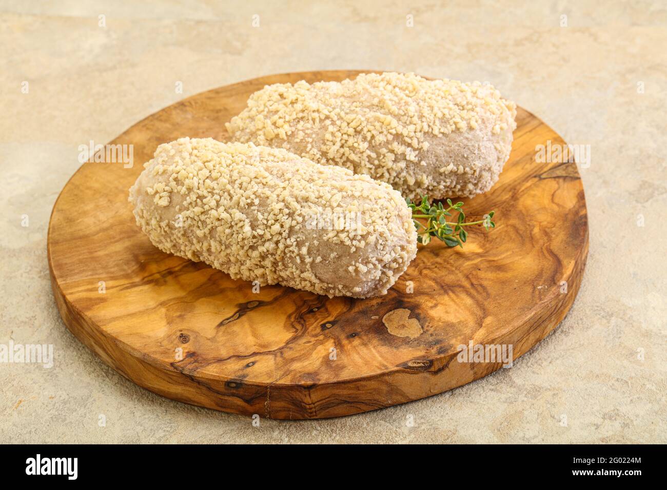 Raw breaded chicken cutlet for roast Stock Photo - Alamy
