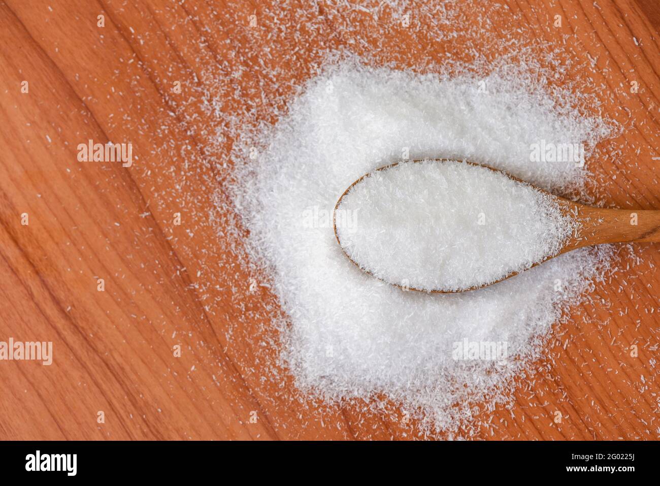 MSG for food seasoning, Monosodium glutamate on spoon and wooden table ...