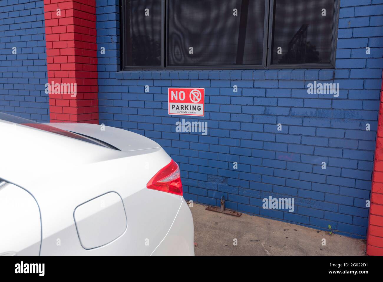 The rear of an unidentifiable car parked in a no parking area in front ...