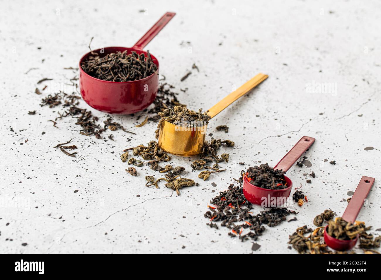 Set of different dry tea in measuring spoons Stock Photo - Alamy