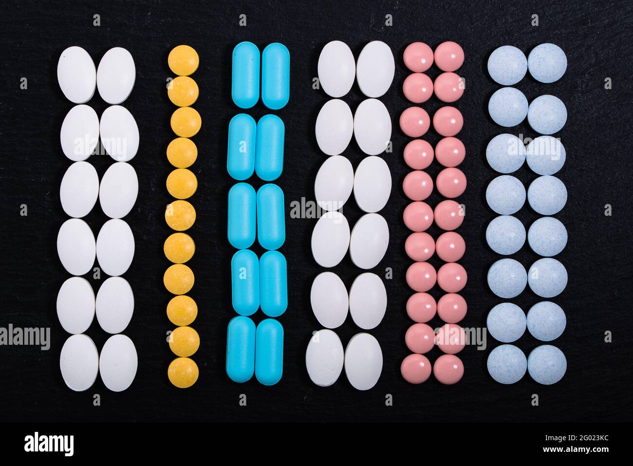 Background with medicines. Tablets, pills on dark board. Pharmaceutical ...