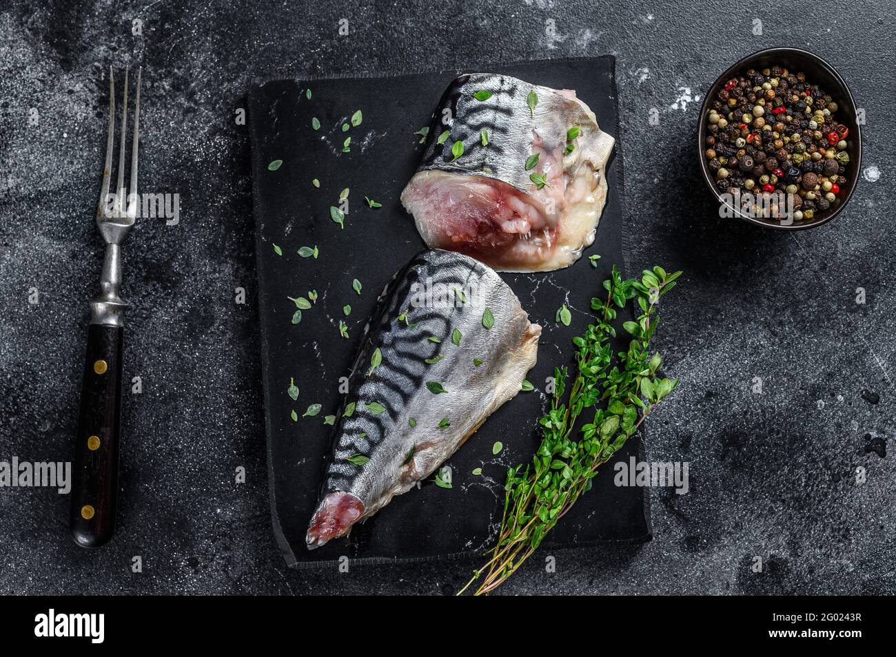 Cold smoked mackerel fish with herbs. Black background. Top view Stock ...