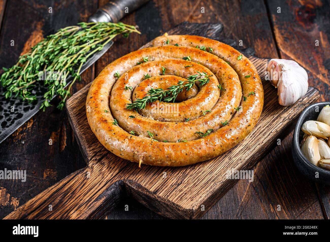 BBQ spiral sausage from pork and beef meat on a wooden cutting board ...
