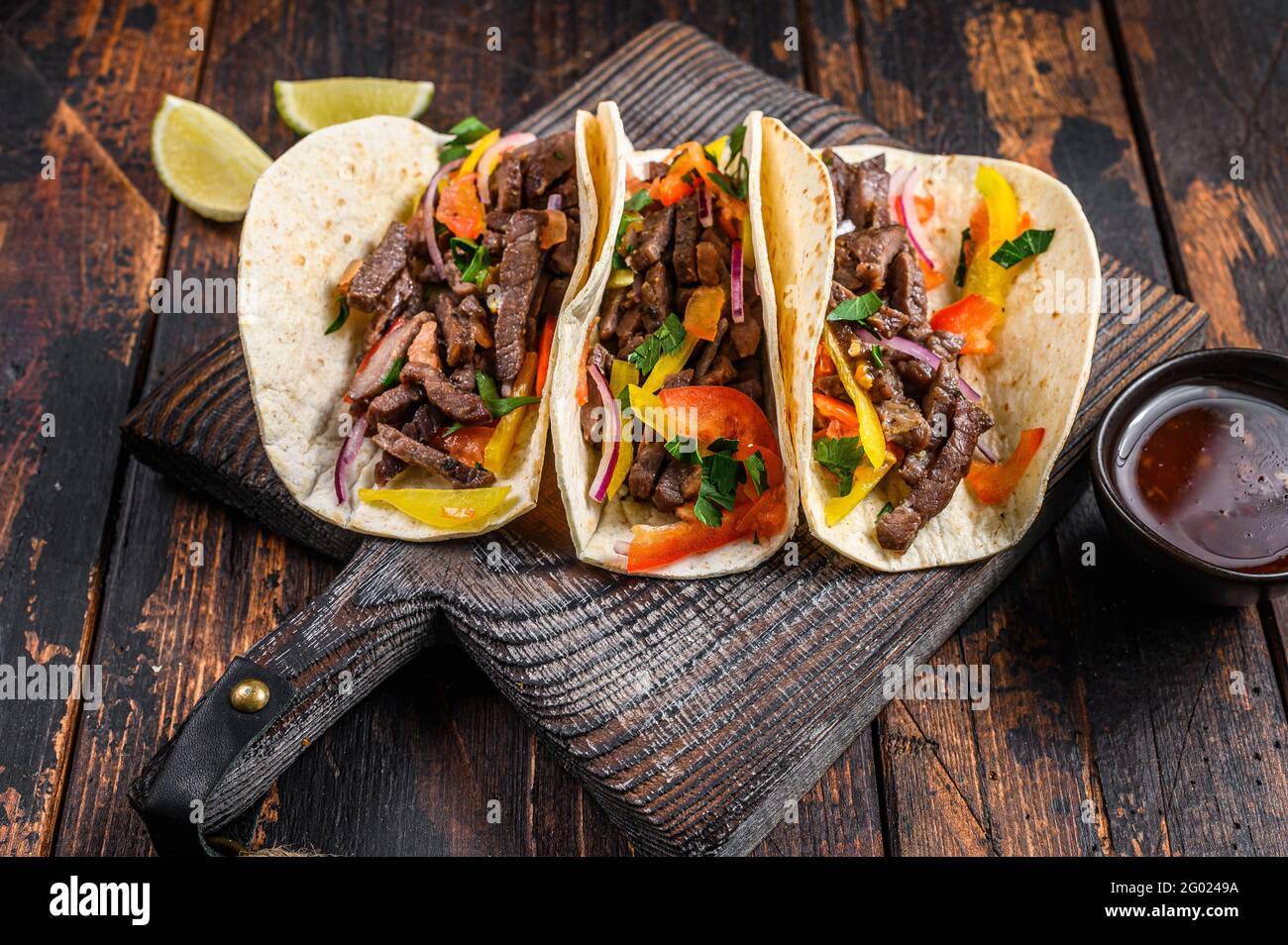 Tacos shells with pork meat, onion, tomato, sweet pepper and salsa ...
