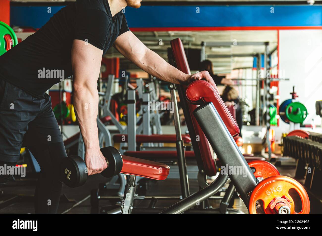 Training with dumbbells in the gym. Strength exercises for endurance ...