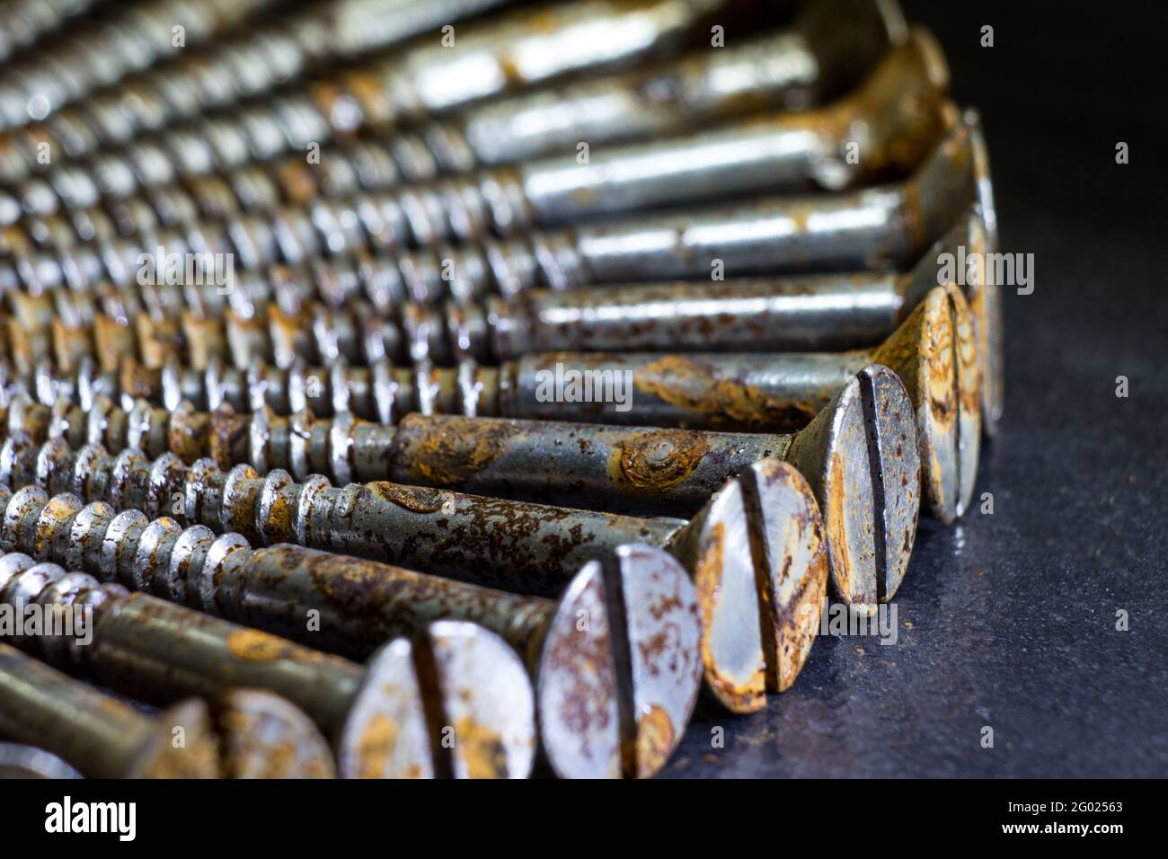 Rusty scattered screws lying on ground. Metal industry Stock Photo - Alamy