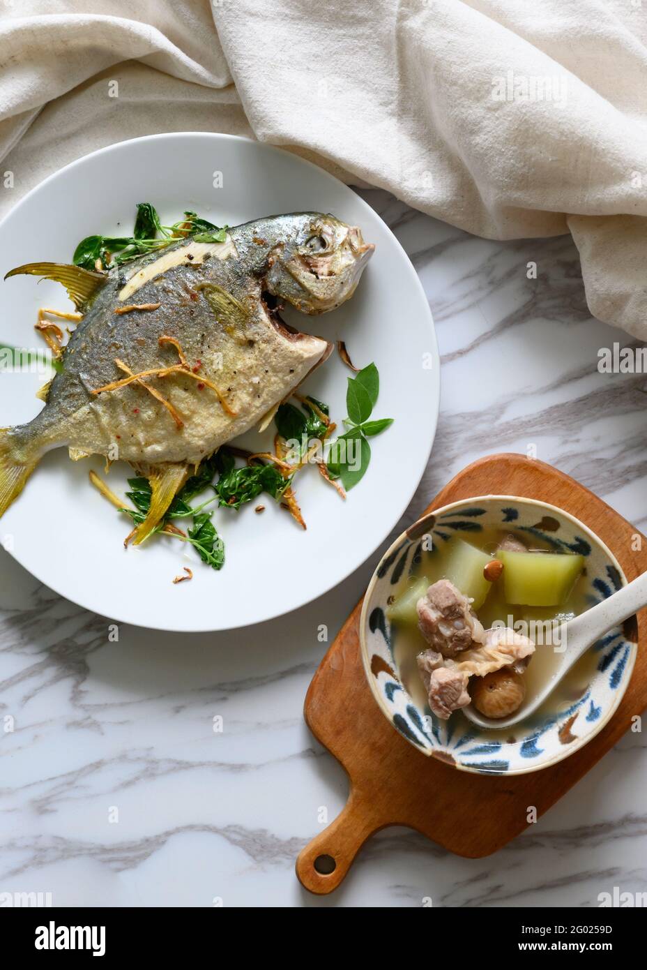 Fried Pomfret and Bone Soup Stock Photo - Alamy