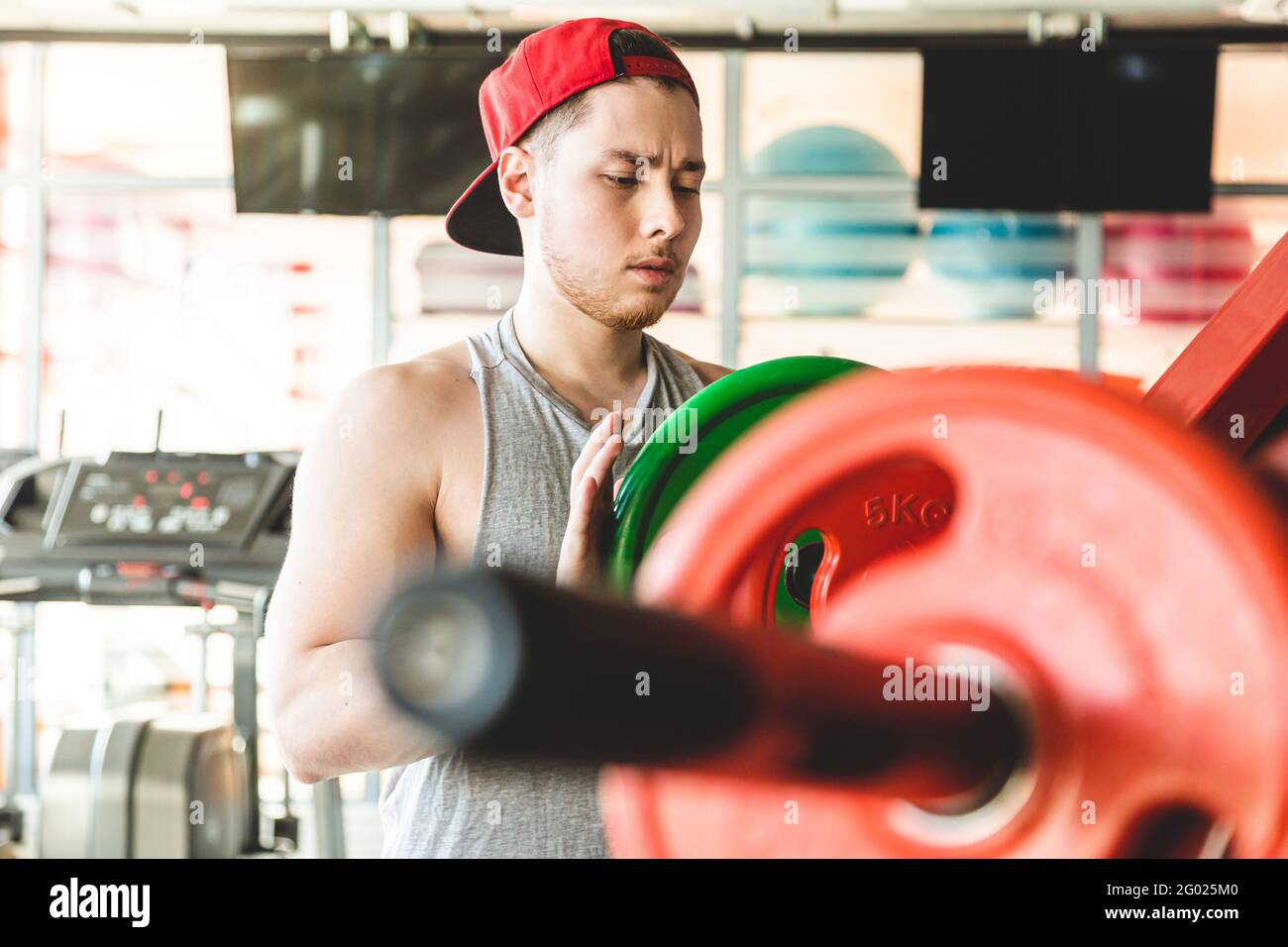 Strength training of a muscular young athlete in the gym. Stamina and ...