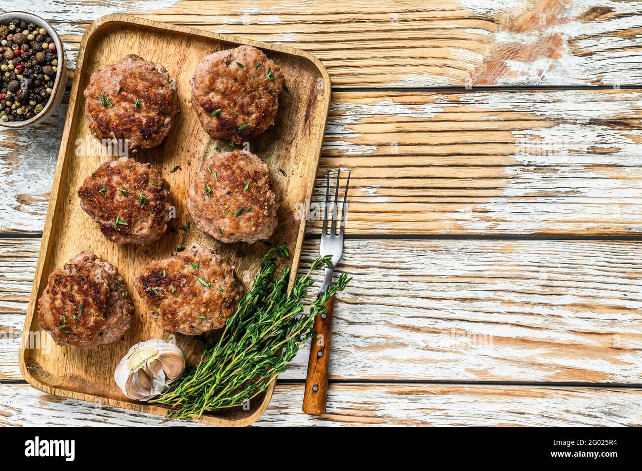 Fried meat chicken cutlets on a wooden tray. White background. Top view ...