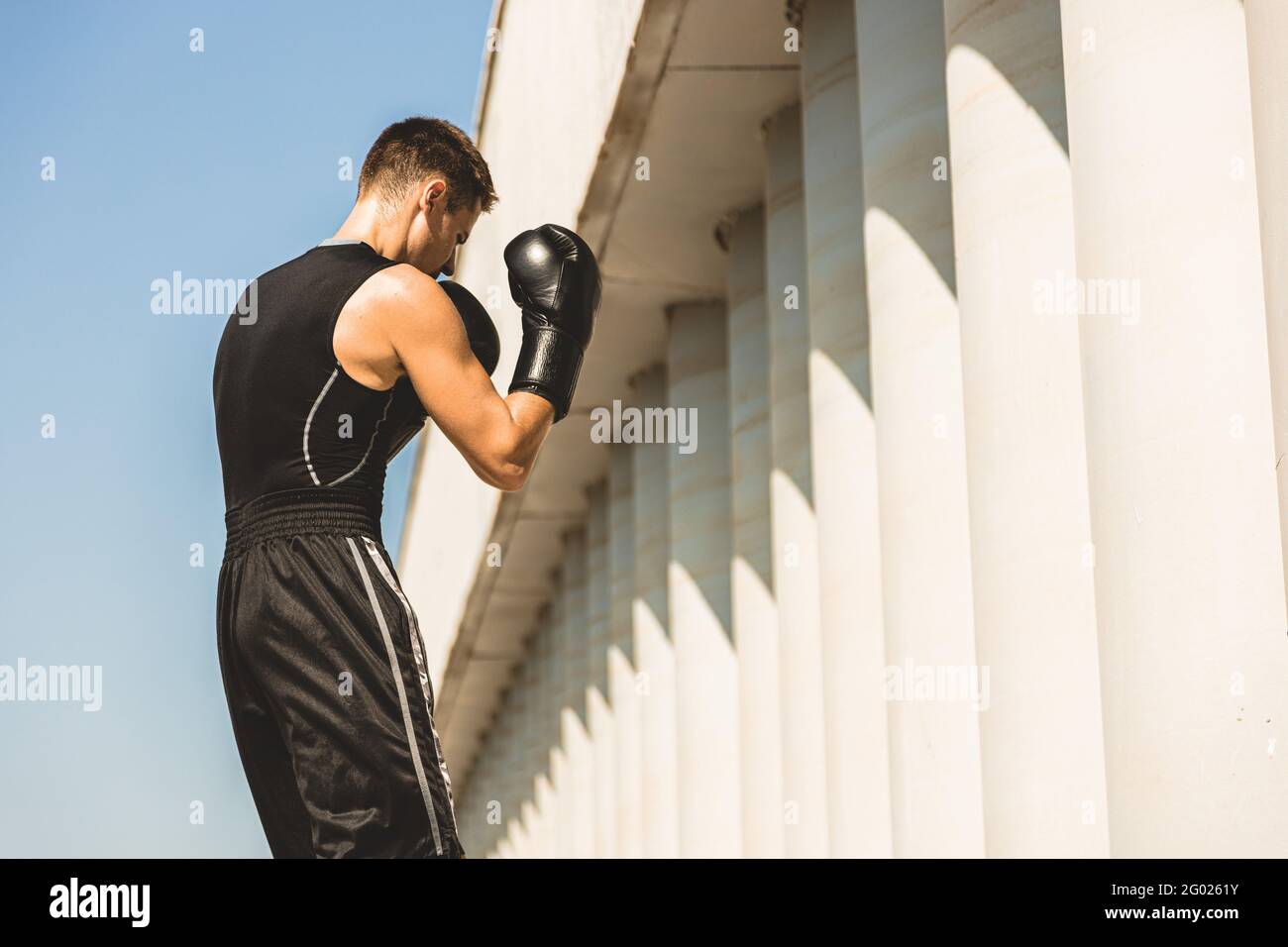 Man exercising and fighting in outside, boxer in gloves. male boxer ...