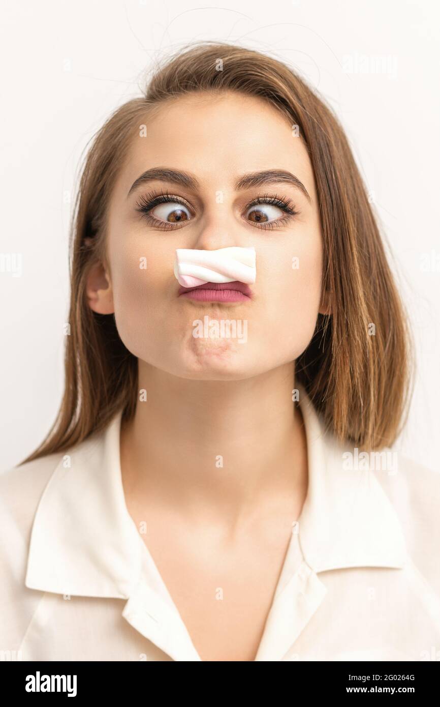 Young funny woman with sweet candy marshmallow-like mustache over white ...