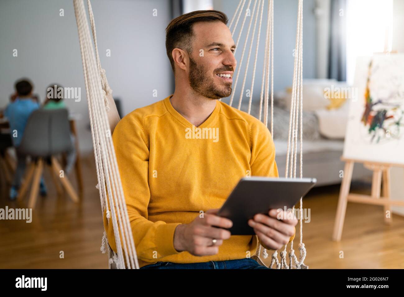 Portrait of handsome young happy man using digital tablet Stock Photo ...