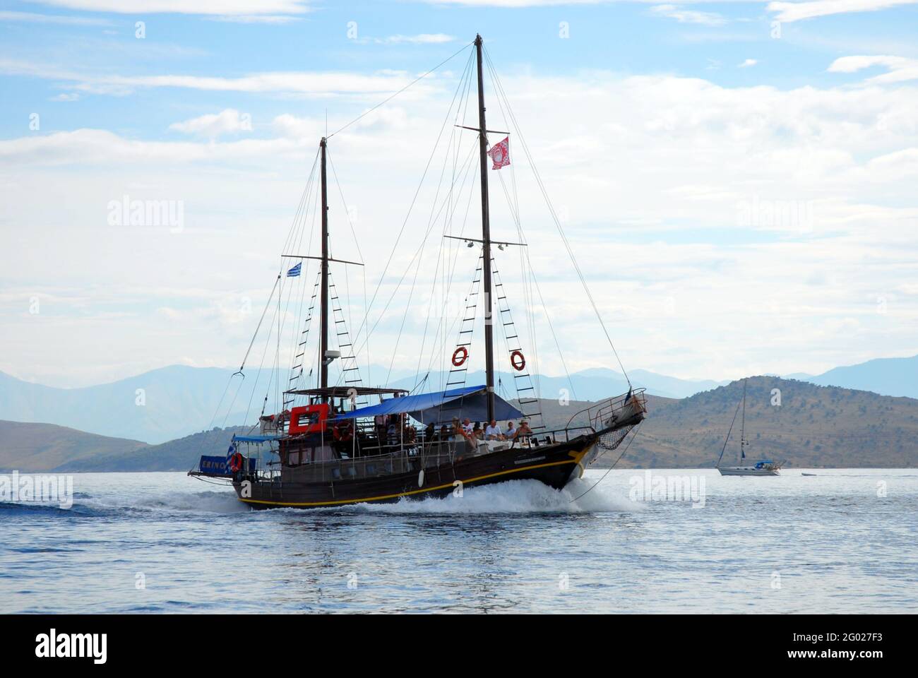 Two-masted vessel, flying the Greek flag, at sea offshore from Corfu ...