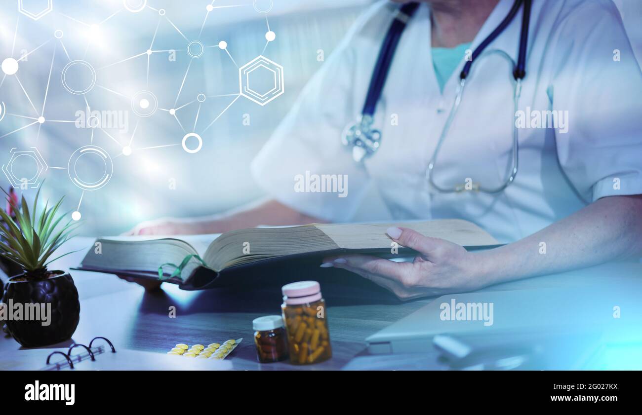 Female doctor reading a textbook in medical office; light effect Stock ...