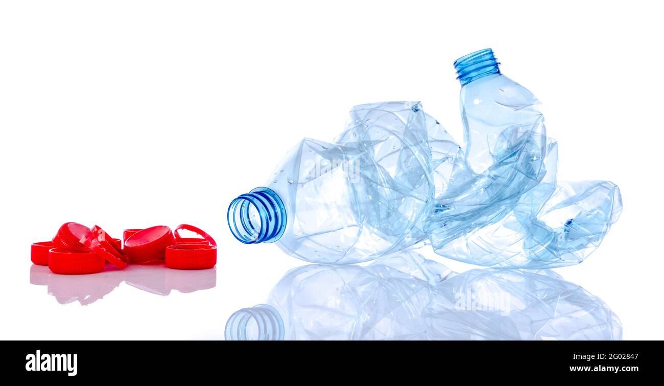Crushed plastic bottles with caps, isolated on white Stock Photo - Alamy