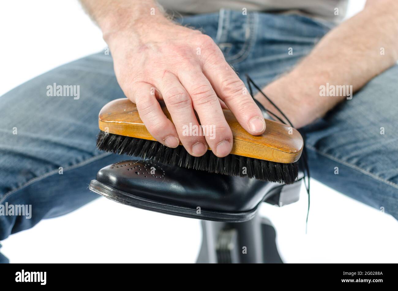 Shoe shiner polishing a black shoe with a brush Stock Photo - Alamy