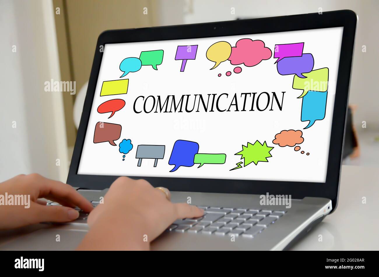 Hands on a laptop with screen showing communication concept Stock Photo ...