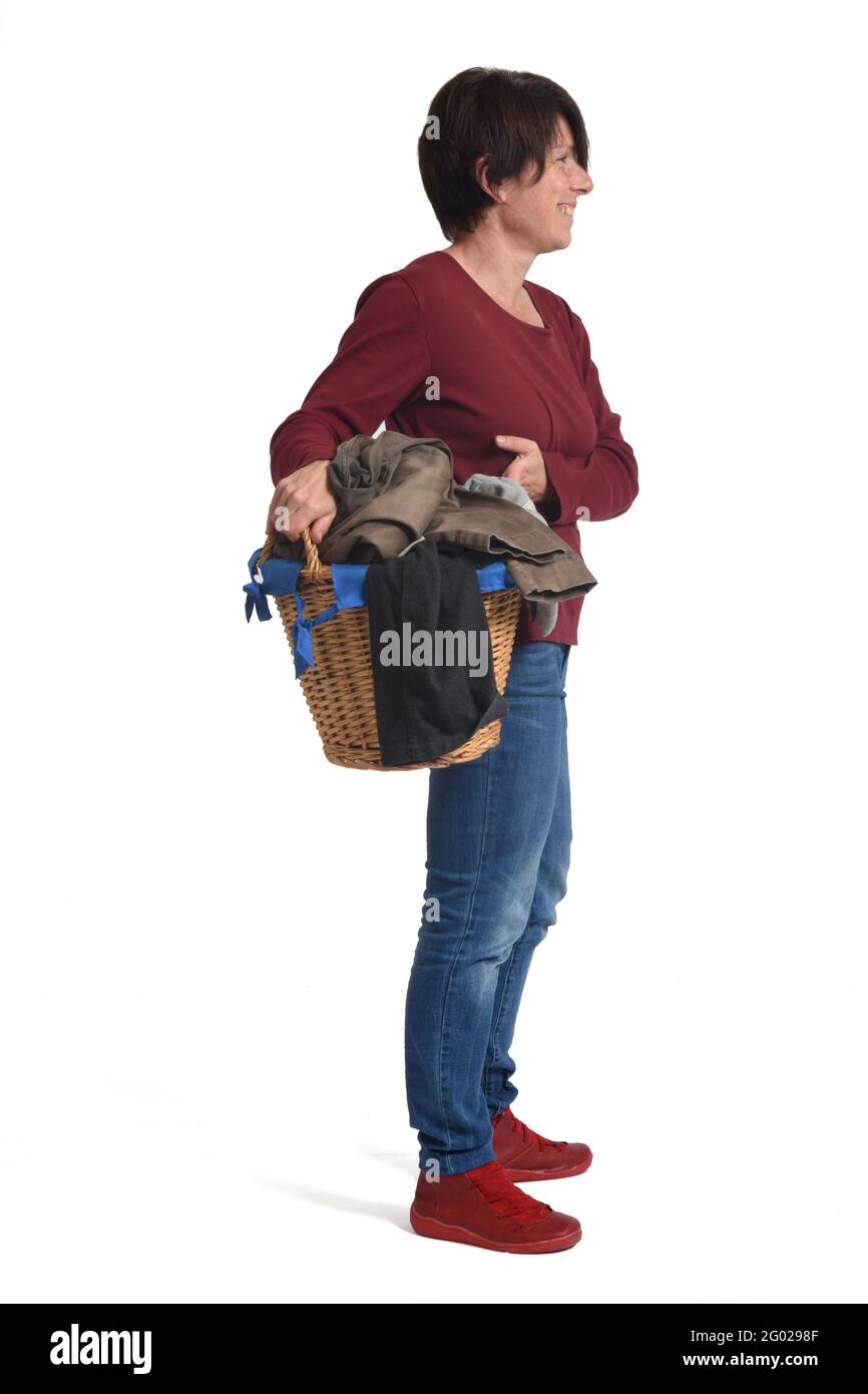 side view of a full portrait of a woman with a laundry basket on white ...