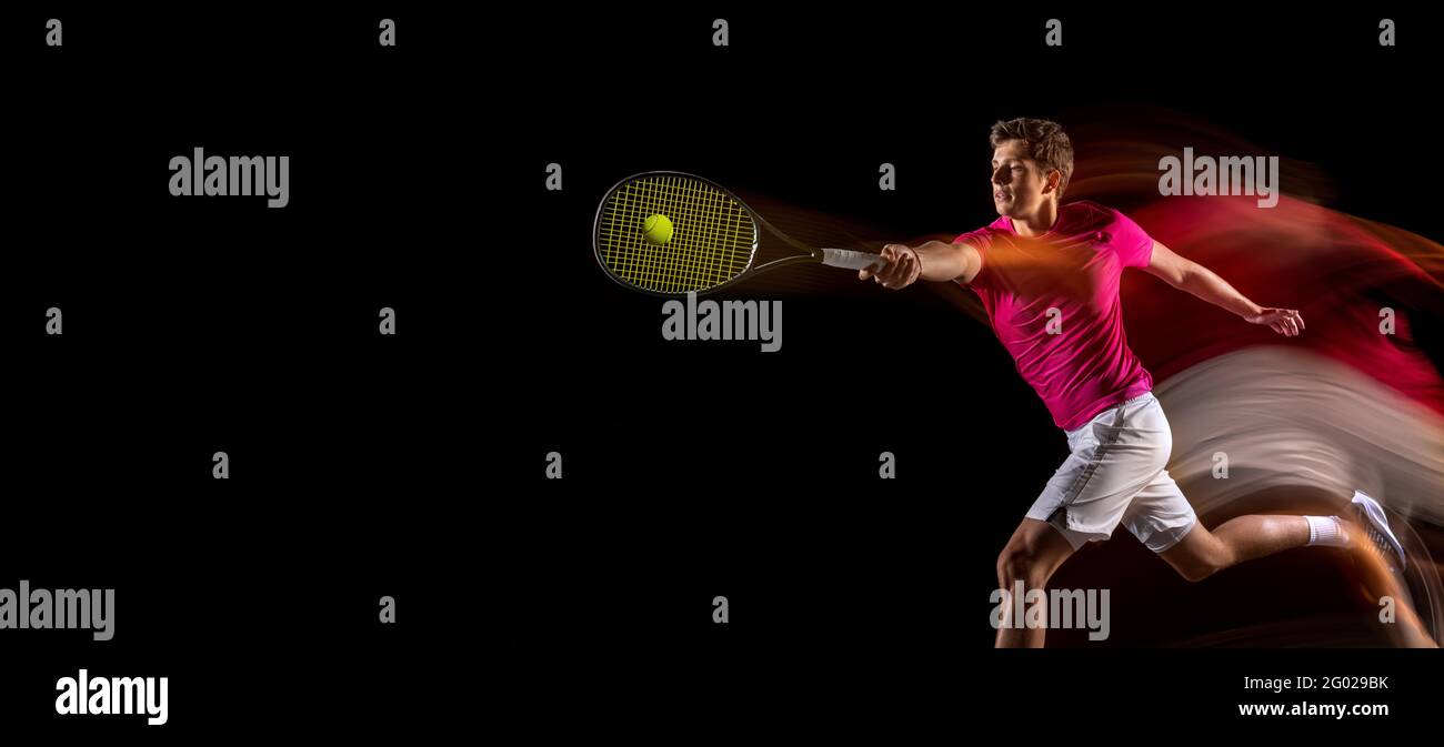 One man, male tennis player training isolated in mixed neon light on ...