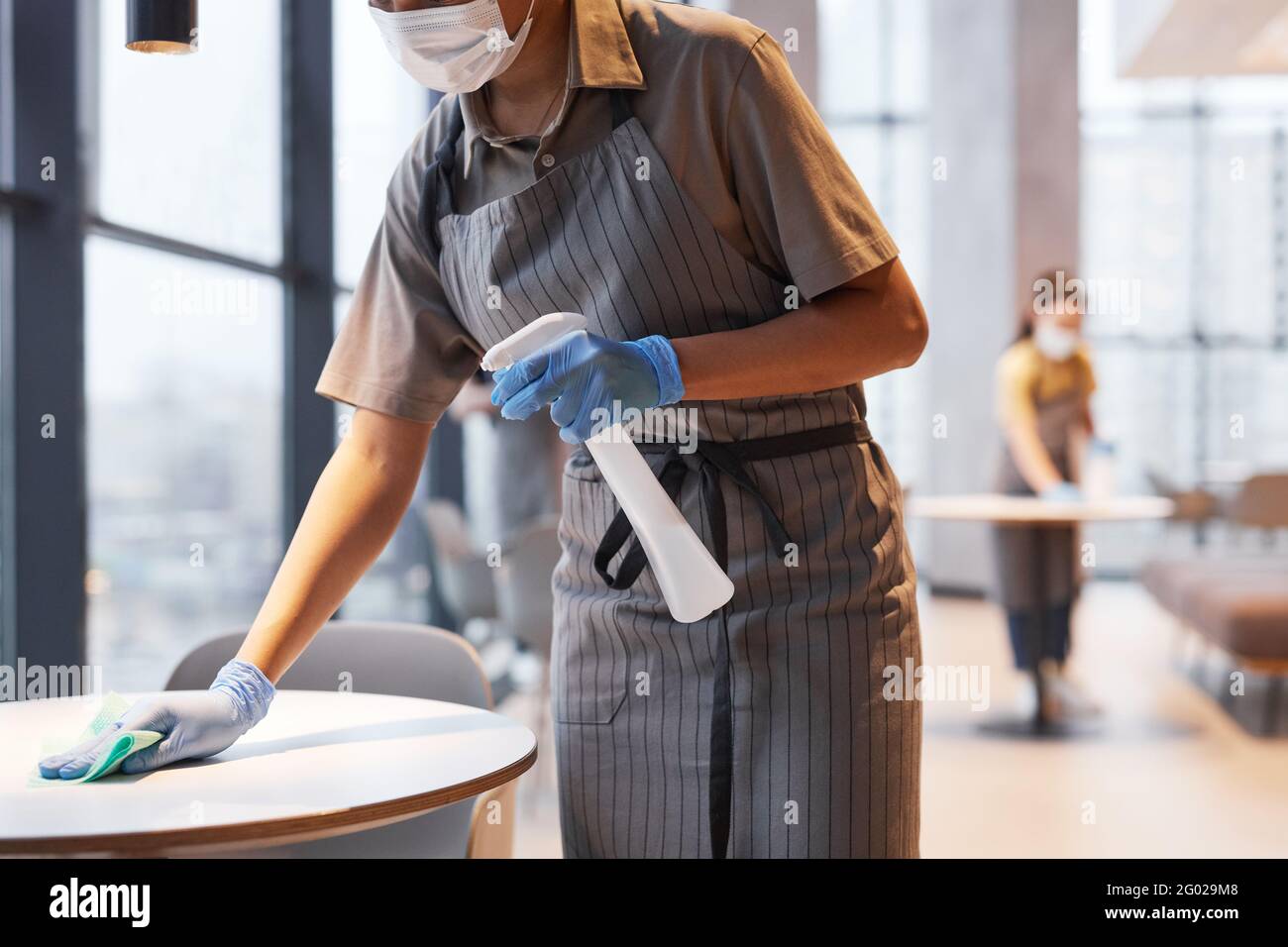 Person cleaning tables hi-res stock photography and images - Alamy