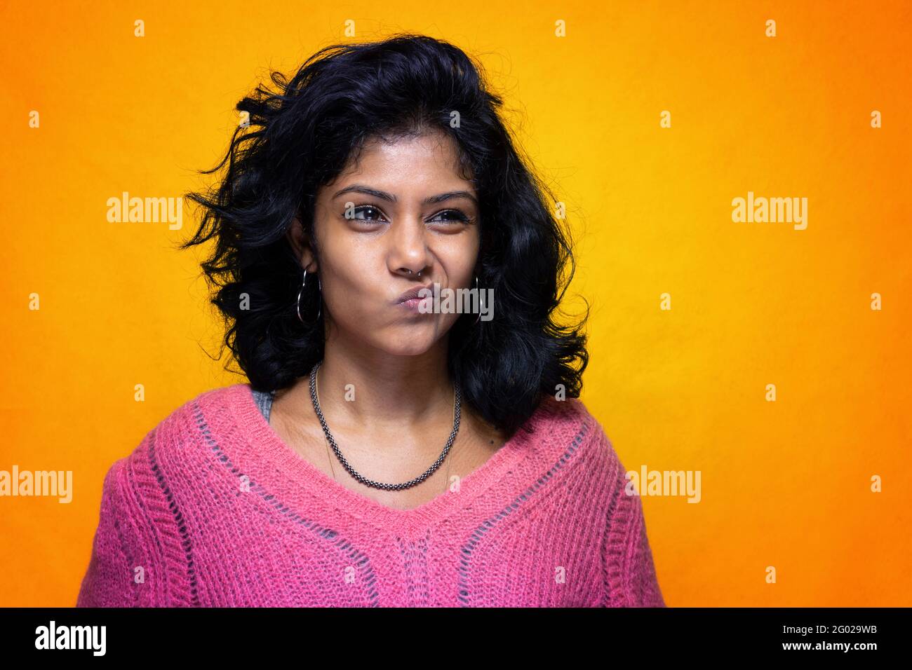 Beautiful Sri Lanka girl poses standing with yellow bright background ...