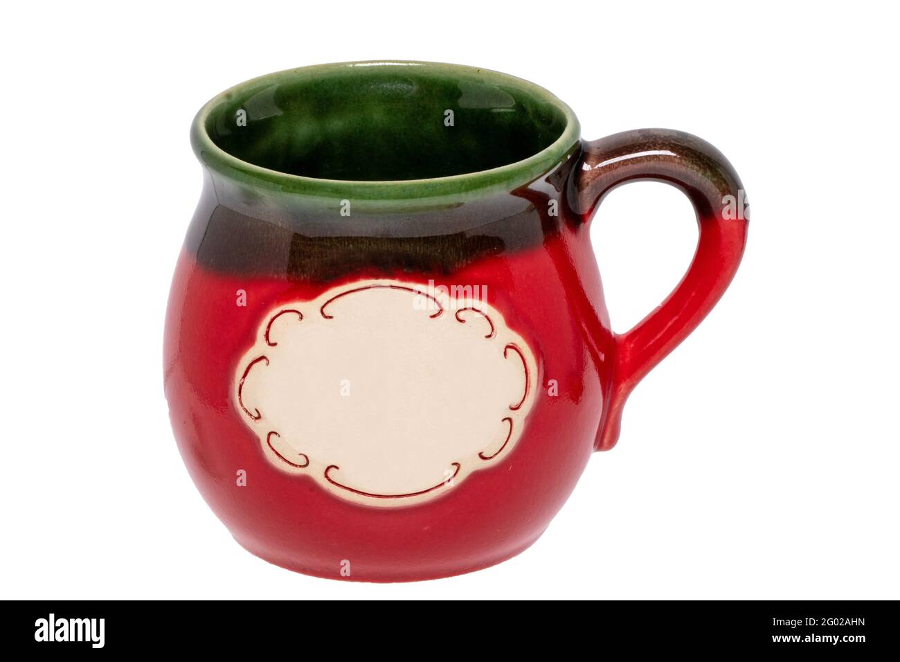 Mug for coffee. Close-up of a empty red green ceramic cup with an empty ...