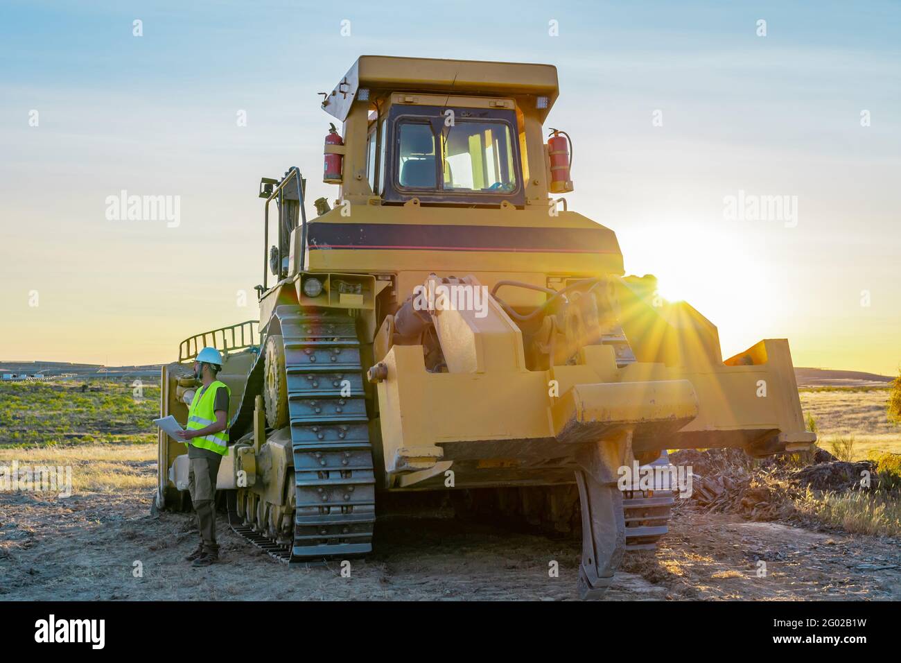 Construction manager, heavy machinery driver next to excavator ...