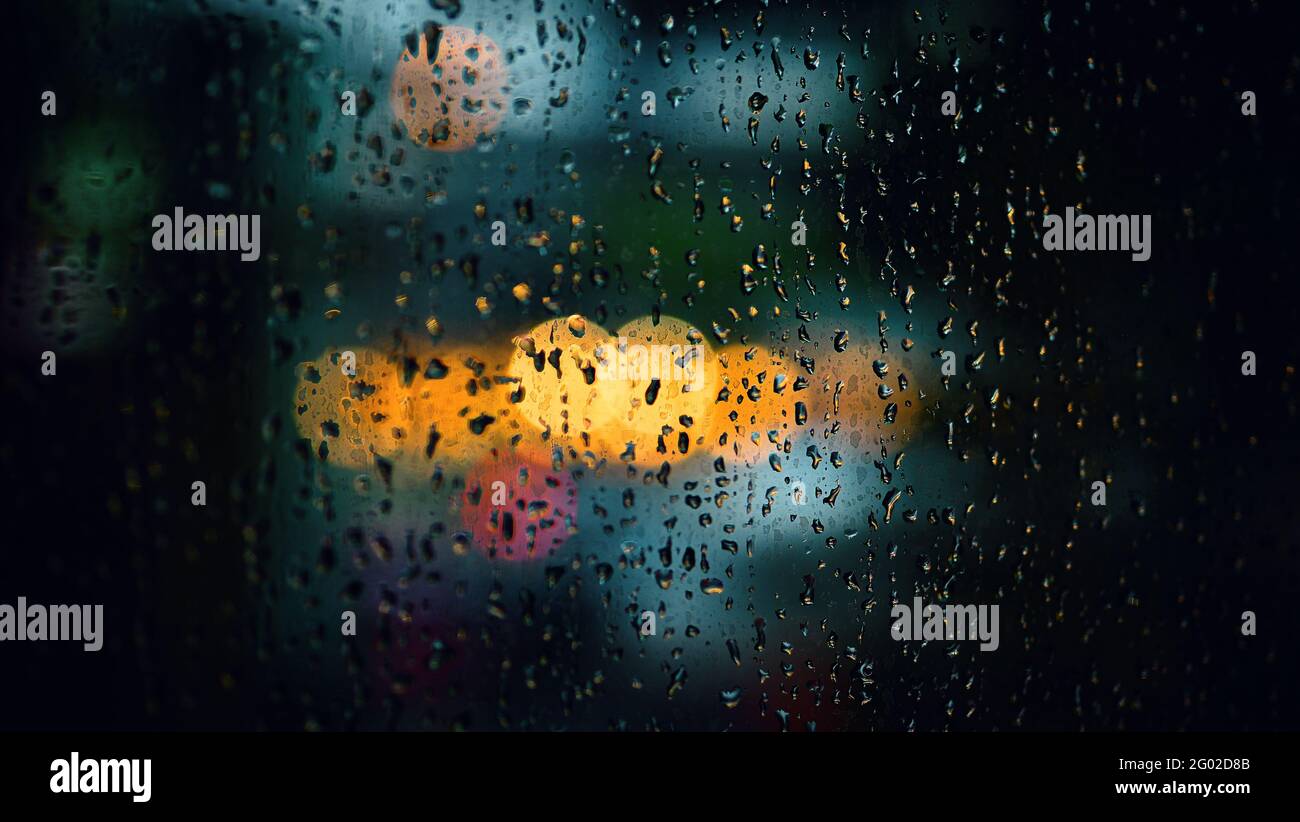 Rain drop on window at night. Condominium or apartment living room ...