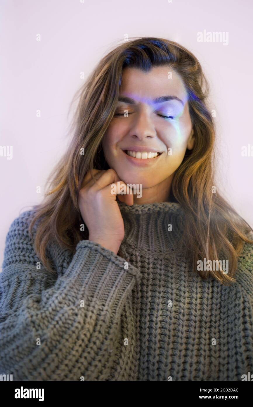 Self-portrait of a beautiful smiling Spanish woman with rainbow shadow ...