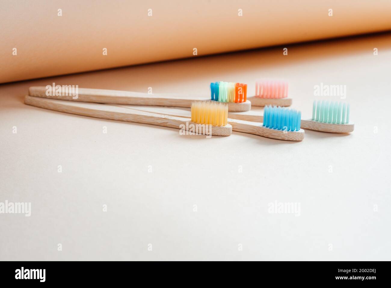 Colorful eco friendly bamboo toothbrushes on light pastel background ...