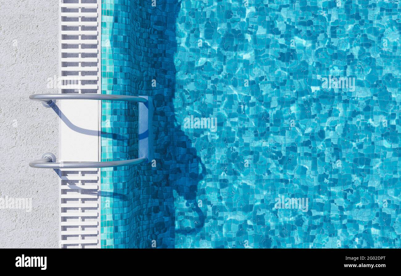 top view of a swimming pool with metal ladders and skimmer curb on a ...