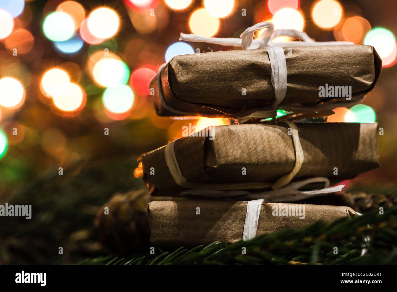 Xmas presents, christmas background with lights glowing on tree at eve ...