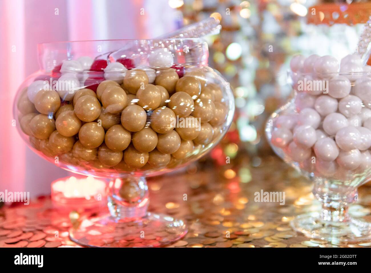 Closeup shot of round brown and white chocolate candies on a glass bowl ...