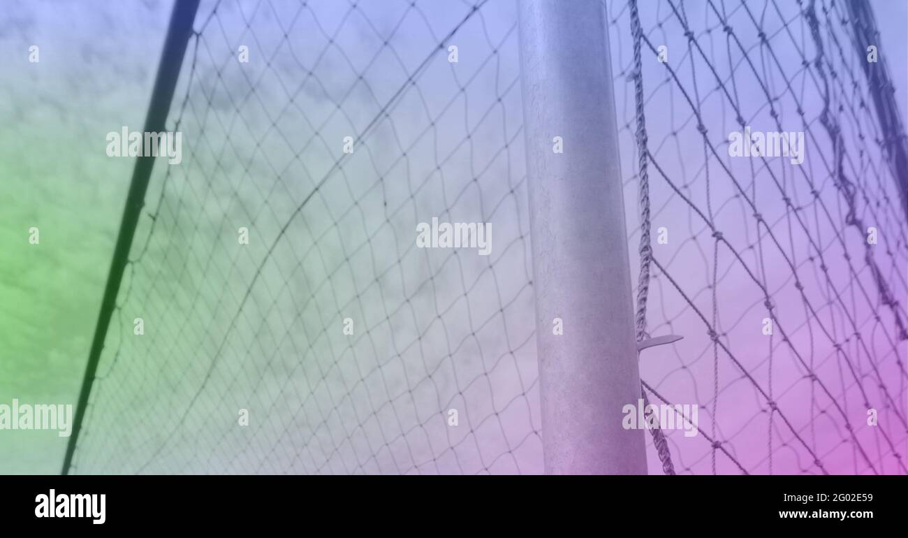 Composition of close up of football goal with purple to green tint ...