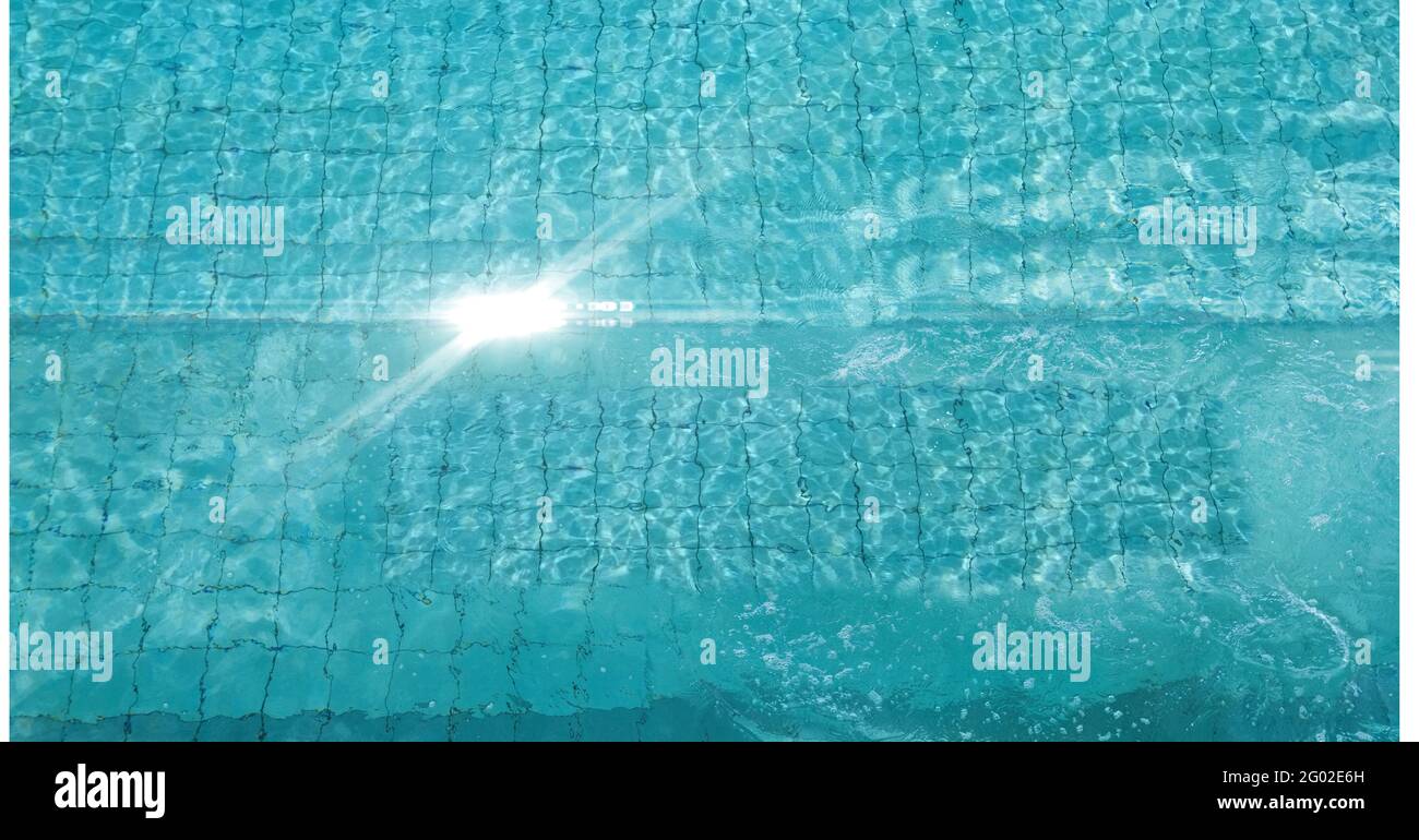 Composition of swimming pool with clear water, glowing light and copy ...