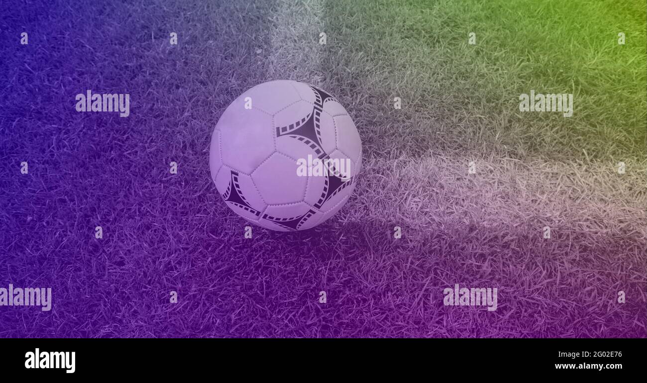 Composition of football on white line on grass pitch with copy space ...
