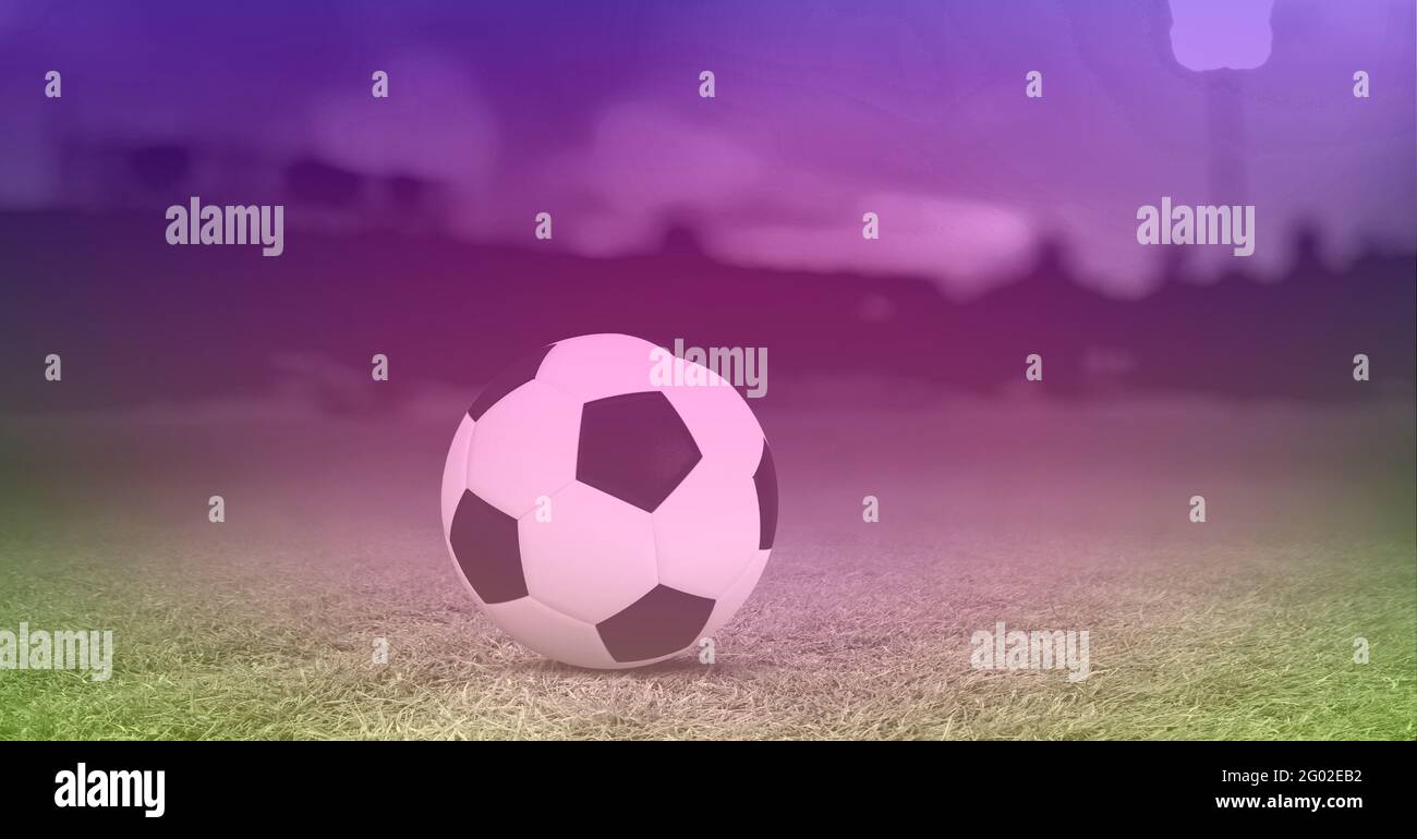 Composition of football on grass pitch with copy space and purple tint ...